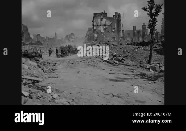 1944 - American soldiers drive tanks through the rubble of war-torn St ...