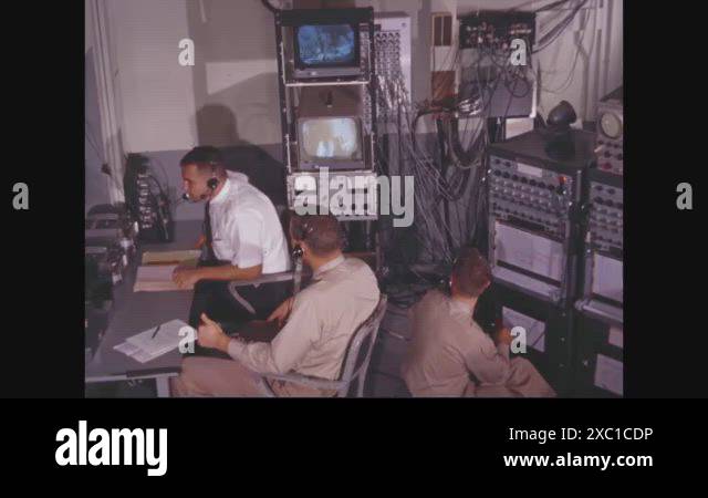 1963 - US Navy officers, doctors, and technicians carefully study ...