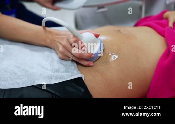 Pregnant belly of a woman on the early stages of pregnancy. Doctor's ...