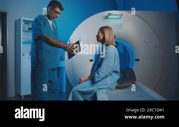 Medium shot of diagnostic male radiologist having pre-scan preparation ...