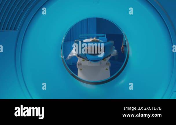 Inside view of CT scanner with woman lying on sliding patients table ...