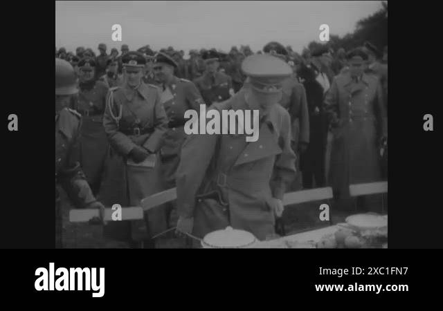1938 - Adolf Hitler eats at an outdoor banquet, then is driven down a ...