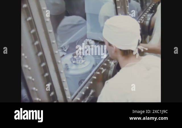 1969 - NASA scientists handle canned items in a vacuum chamber and ...