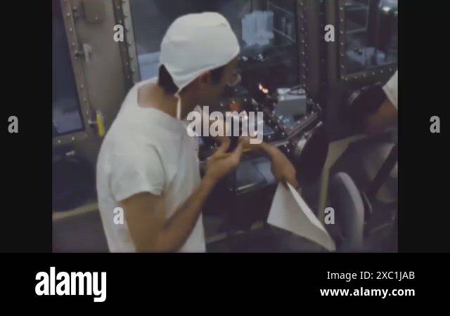 1969 - NASA scientists handle canned items in a vacuum chamber at the ...