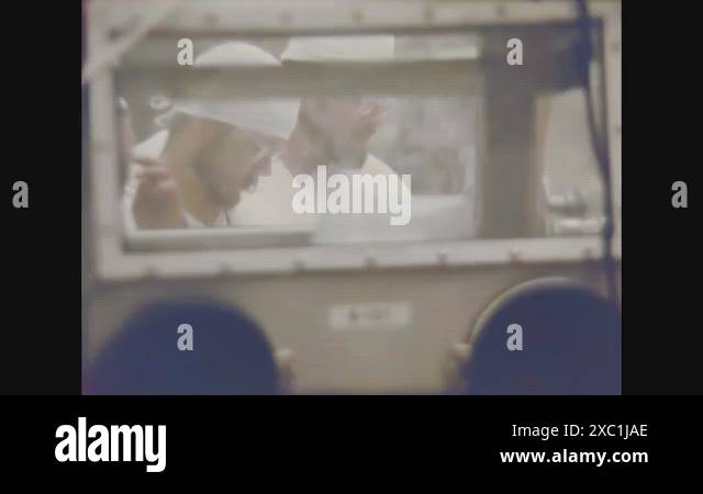 1969 - NASA scientists work in a vacuum chamber and at their consoles ...