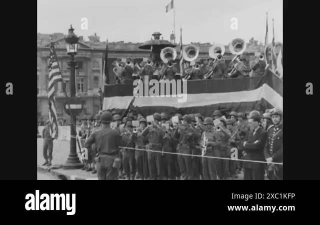 1944 - A US Army band plays on a grandstand for a military parade down ...