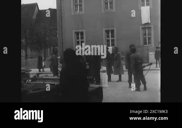 1945 - Captured Nazi officers are gathered in a German town, and an ...