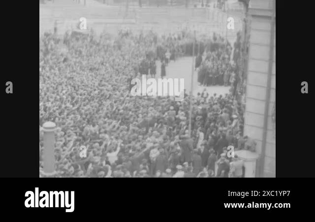 1938 - Nazi troops pass in review, and crowds cheer as Adolf Hitler's ...