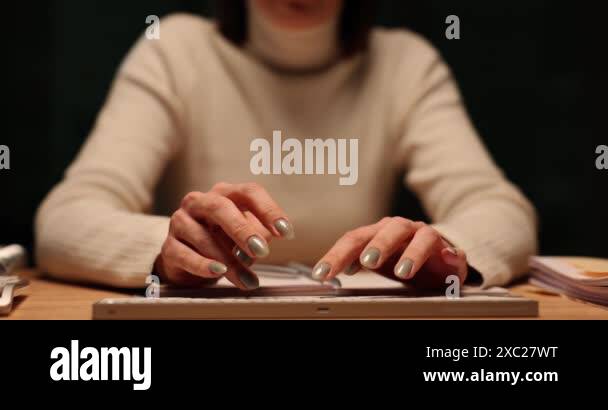 Female office worker types information on wireless keyboard at ...