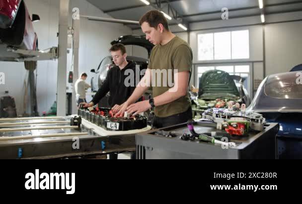 Technicians working on the assembly and repair of a high-voltage ...
