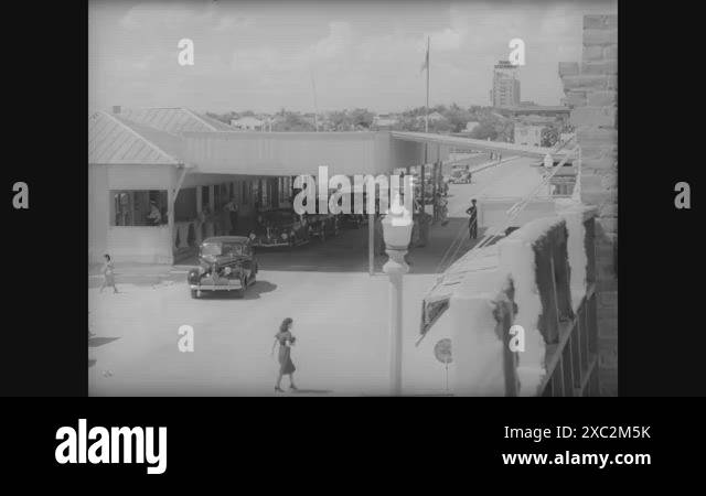 1935 - Cars drive through a checkpoint at the Mexican border, with the ...