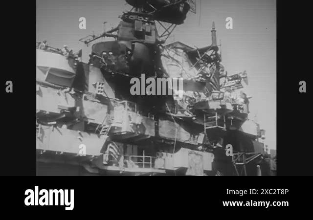 1945 - US Navy sailors on the USS Ticonderoga push wrecked planes ...