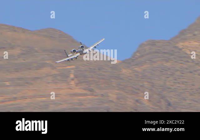 A-10 jet fighter aircraft fire guns and missiles in battle Stock Video ...