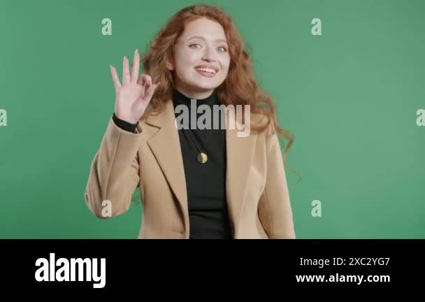 Pretty student woman makes hand sign okay, ok gesture. Happy girl ...