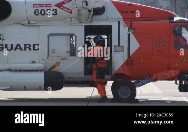 Coast Guard helicopter lands at landing site and injured people are taken by paramedics to ...