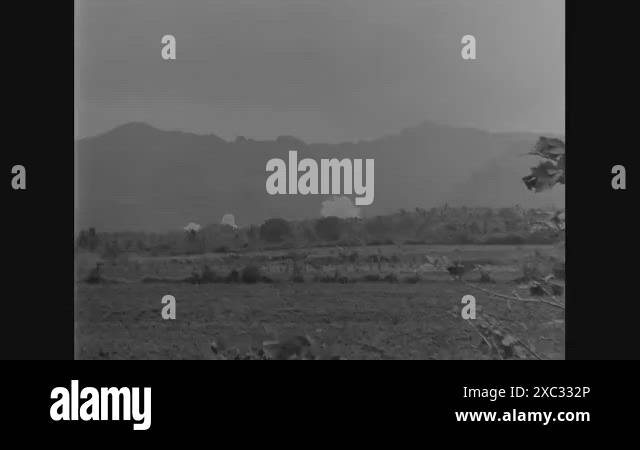1945 - White phosphorous shells burst over a village in the Philippines ...