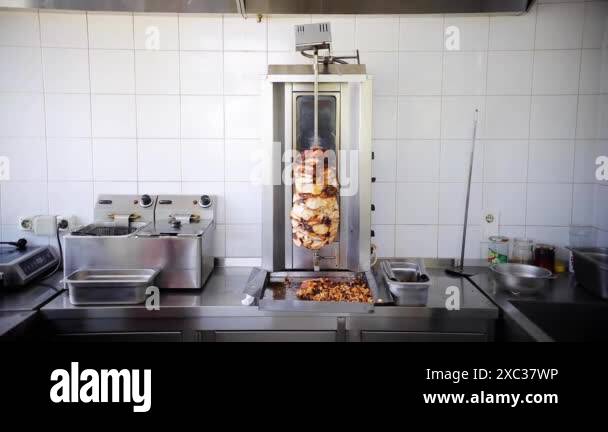 Donner kebab chicken meat or shawarma on a rotating vertical spit. Fat ...