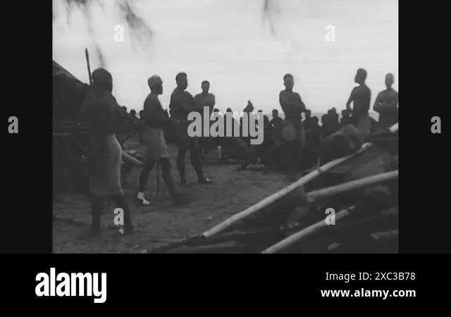 1944 - Native villagers of Aitape help load supplies onto US Navy DUKWs ...