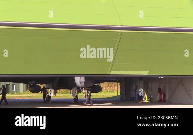 2017 - A hangar opens, revealing a jet inside at an air base in Lithuania Stock Video Footage ...