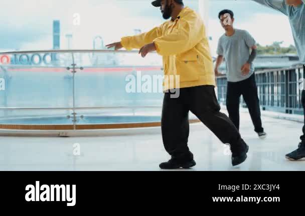Hip-hop teenager group perform b-boy dance at mall corridor with city ...