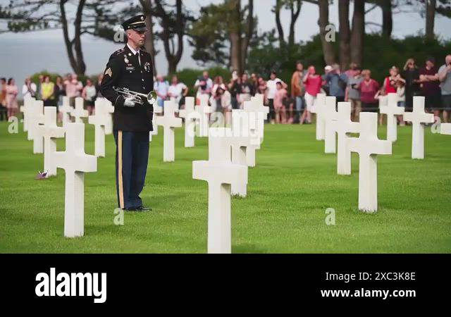 An American soldier plays the bugle at the graveyard near Normandy ...