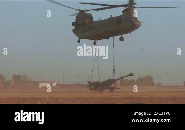 2019 - A helicopter drops off artillery equipment to American soldiers ...