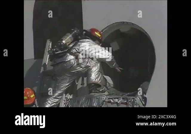 Space Shuttle astronauts are extricated from a cabin mockup, carried on ...