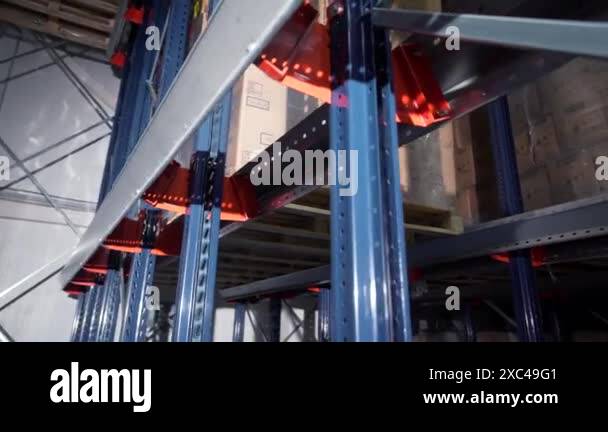 Shelves with boxes in warehouse. Creative. Close-up of iron structures ...