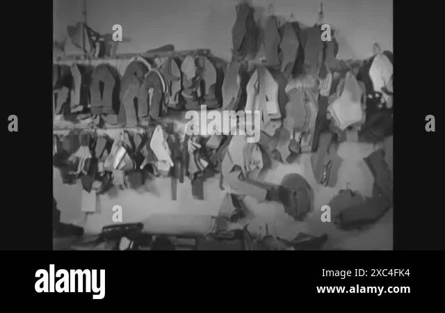 1951 - Shoemakers are working in a shoe store while a woman is having ...
