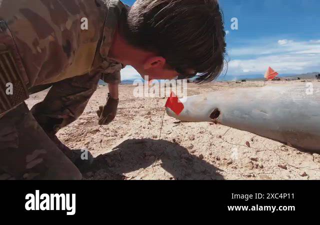 2010s - US Army EOD techs dig a hole for and prepare a munitions piece ...