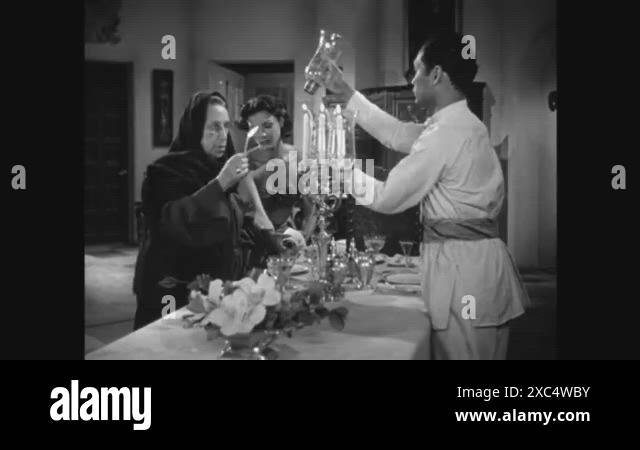 1951 - Servants finish setting a table for the owner of a rubber ...