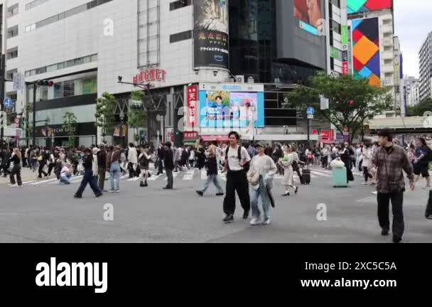 Tokyo, Japan- 12 May 2024: People cross the busy intersection in Shibuya, Tokyo. It is one of ...