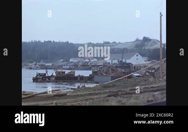 1943 - African-American soldiers use barges to ferry pipes for the ...