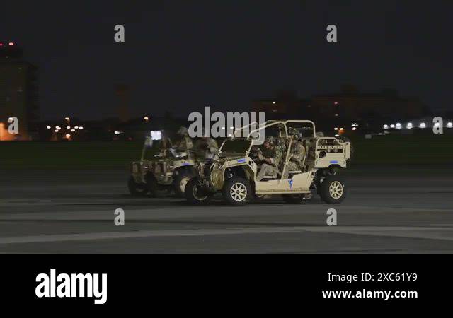 2020 Special operations soldiers load ATVs onto a cargo transport plane ...