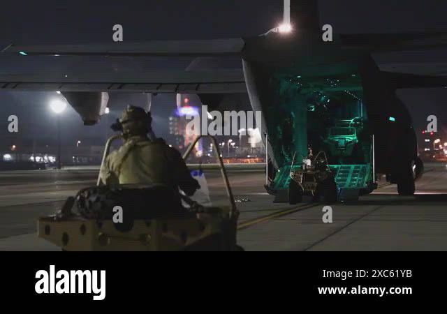 2020 Special operations soldiers load ATVs onto a cargo transport plane ...