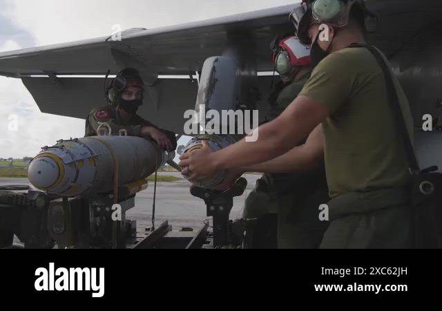 Cockpit footage, ground crew loads munitions onto fighter jet, includes ...