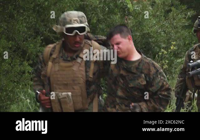 U.S. Marines conduct an air assault course using a helicopter gunship ...