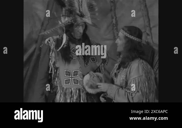 US - 1957 - in this western, a Native American woman shows a chief her ...