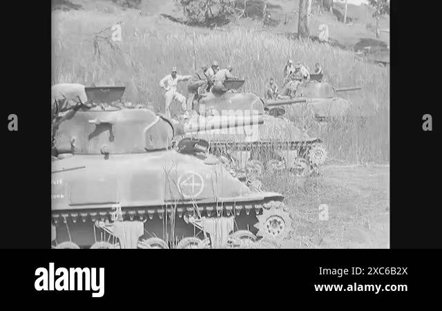 1945 - Men of the 745th Tank Battalion fire guns from medium tanks ...