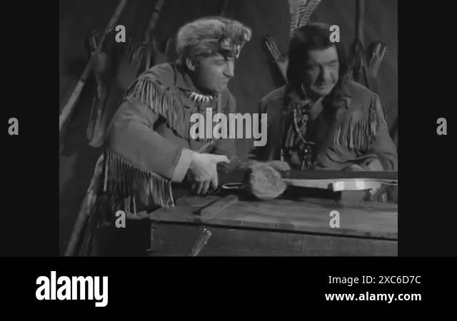 US - 1957 - in this western, a trapper whispers to his Native American ...