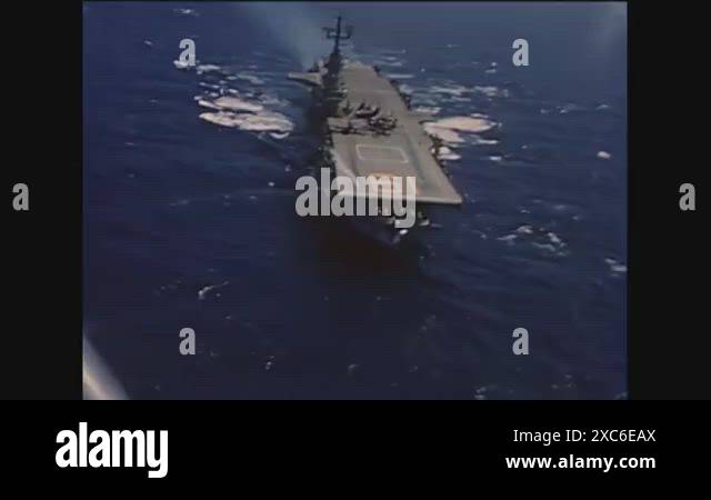 1954 - Aerial view of the USS Hancock, sailing at sea, with several ...