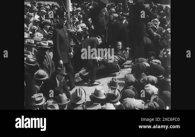 HOUSTON - 1923 - Wearing a straitjacket, Harry Houdini is hoisted up ...