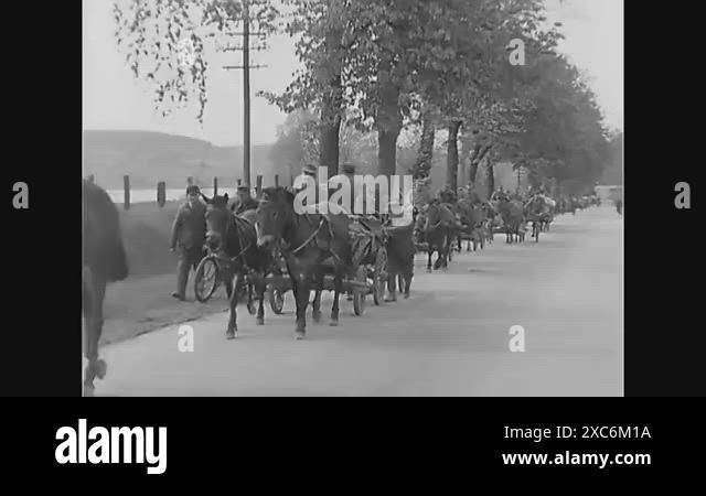 1945 - German soldiers ride in horse-drawn carts and on bikes on their ...