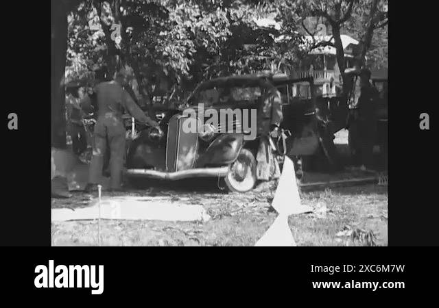 1945 - Military Police in the Philippines examine a car for possible ...