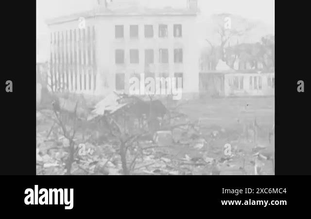 1945 - Machine gun tracers are fired into the windows of a building on ...