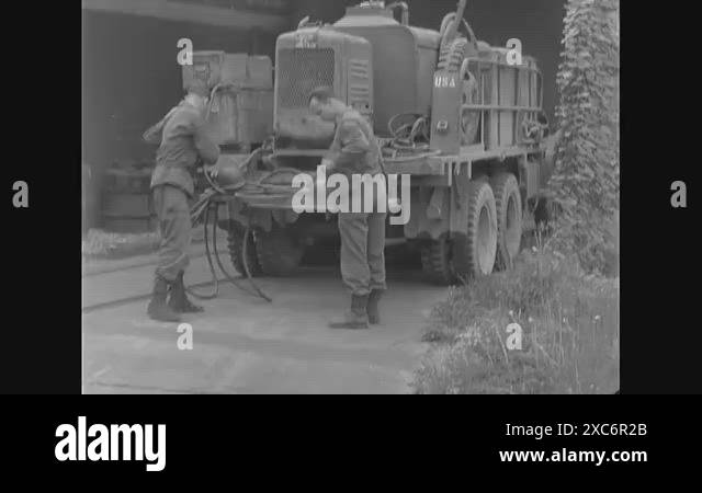 1945 - Two American troops put on gas masks in a German gas dump. They ...