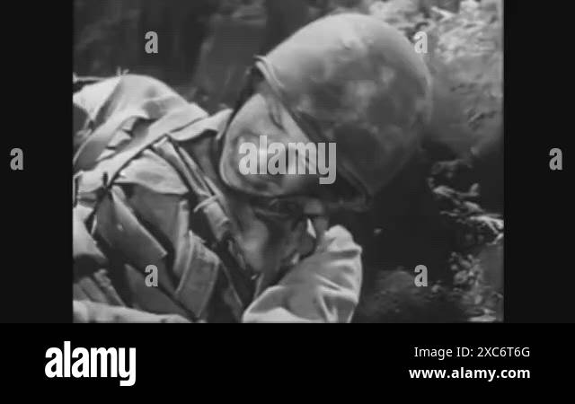 1943 - In this US Army training film, a soldier takes a canteen from a ...