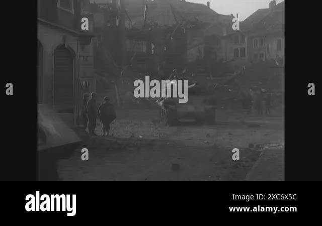 1944 - American troops walk through the wrecked town of Avold, France ...