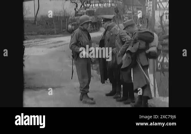 1945 - An American soldier searches three Nazi POWs, one of whom is an ...