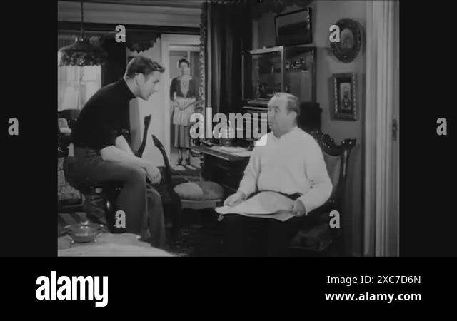 USA - 1950 - In this comedy film, a father scolds his son as he sits in ...